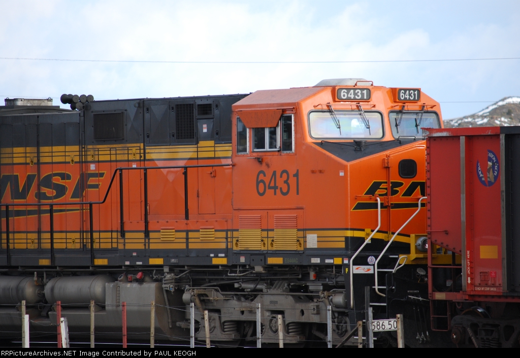 A close up shot of the cab of BNSF 6431 as she rolls west pulling a KCLX coal cars for the ...